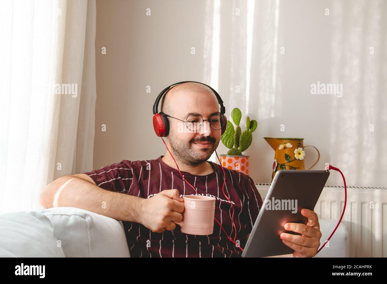 young people having a good time at home. listening to music, drinking ...