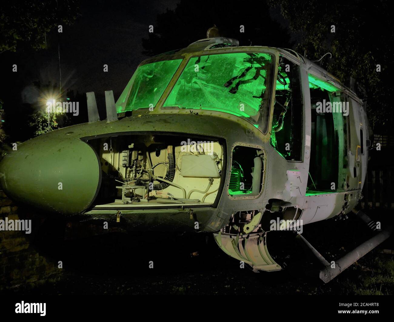 disused abandoned Helicopter grounded at night with green lighting to ...
