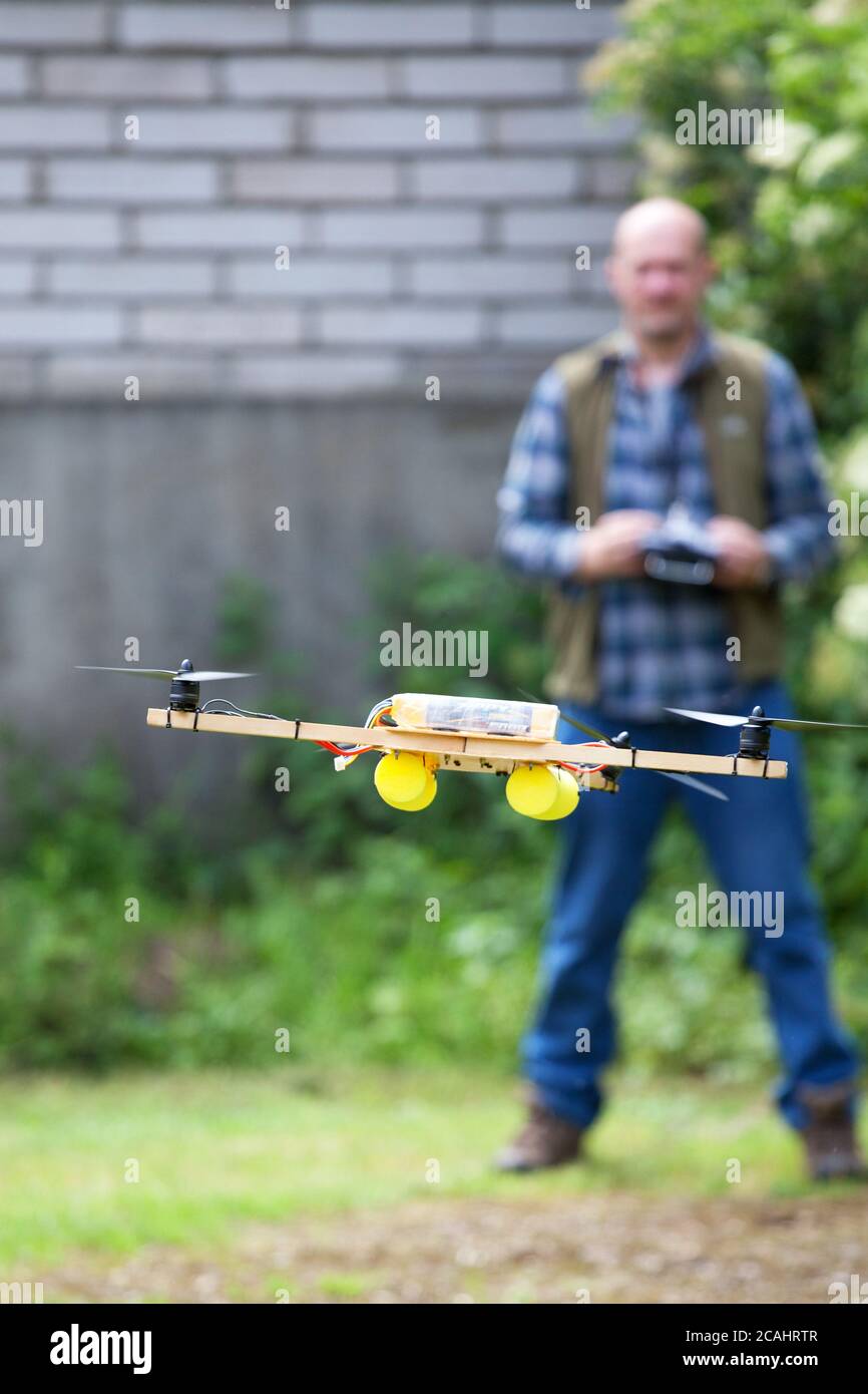 Man flying home-made quad-copter Stock Photo - Alamy