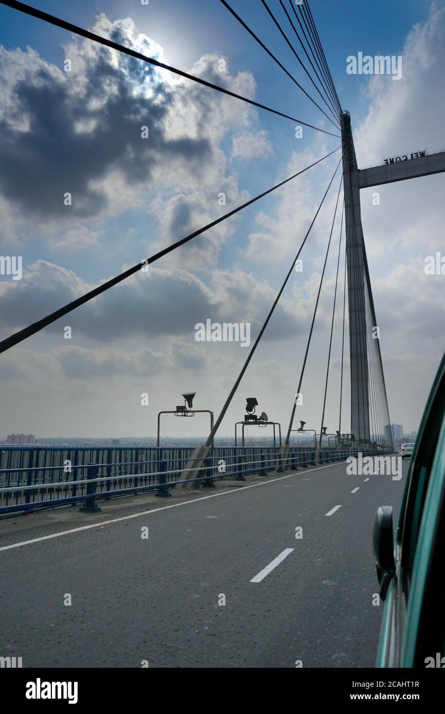 Sun rays passing through clouds in blue sky over 2nd Hoogly Bridge ...