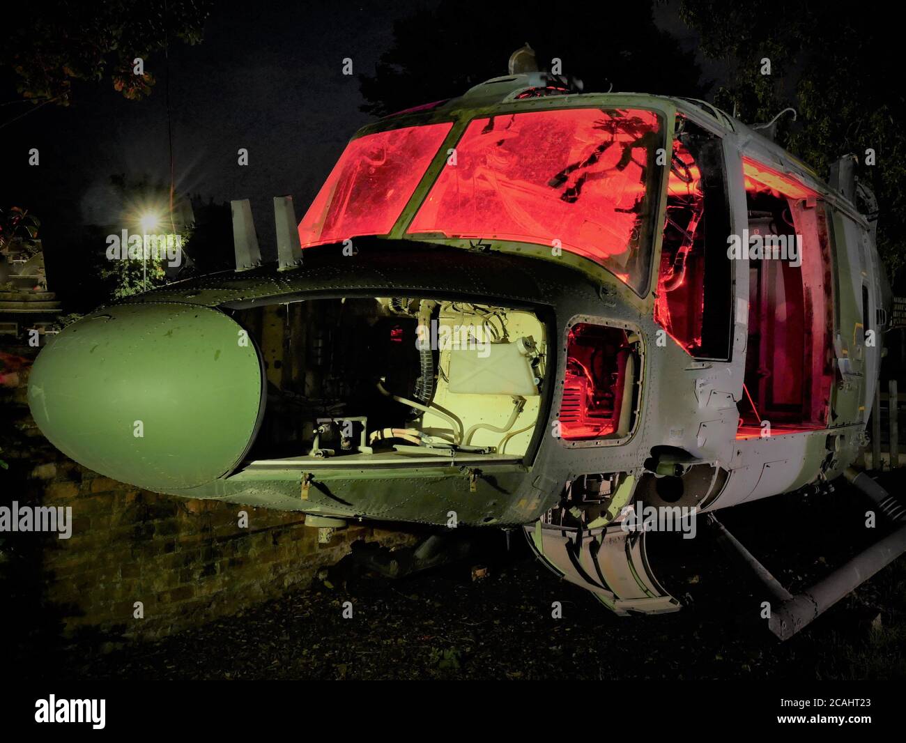 disused abandoned Helicopter grounded at night with red lighting to ...