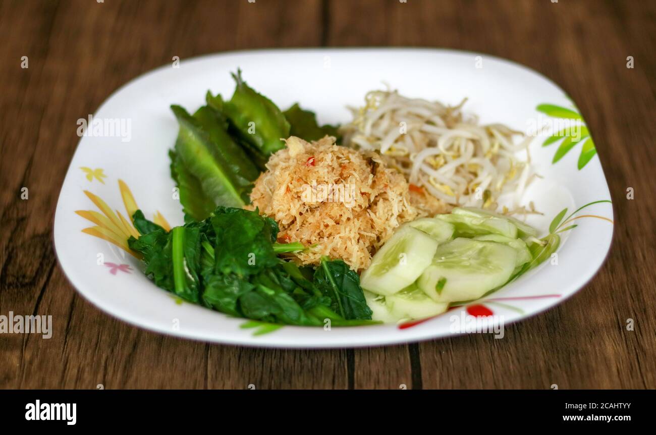 Sayur urap on wood background. Cooked vegetables with spiced grated ...