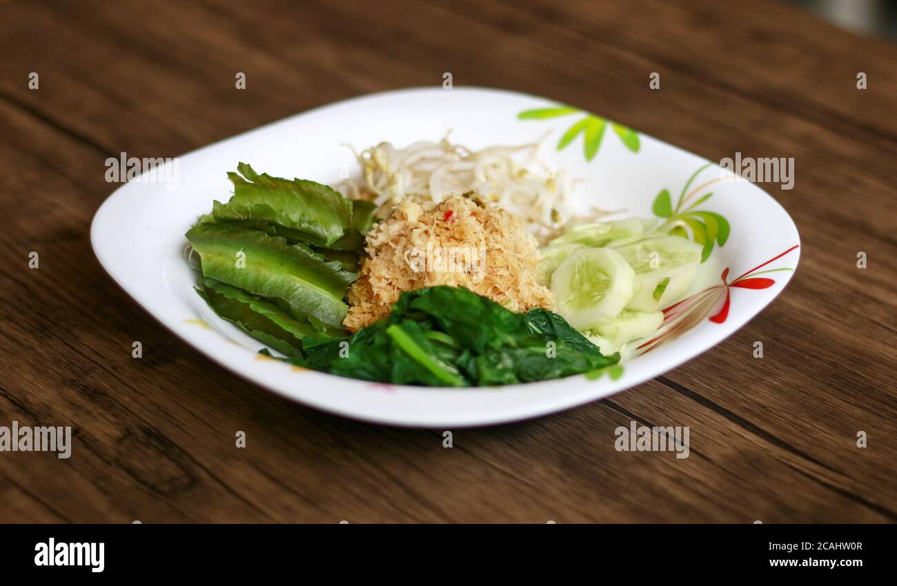 Sayur urap on wood background. Cooked vegetables with spiced grated ...