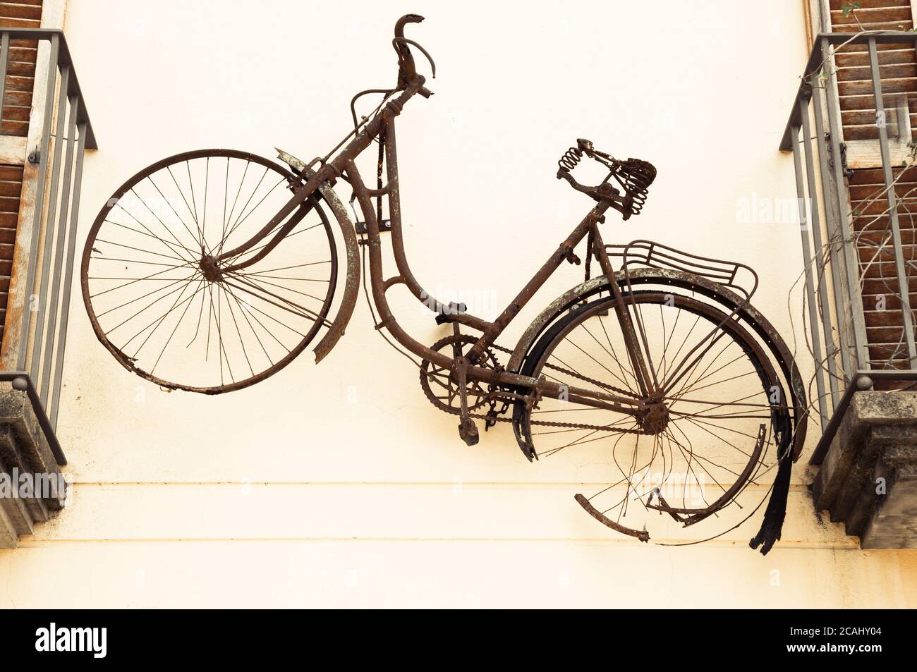 Broken rusty weathered bike on a white wall background Stock Photo - Alamy