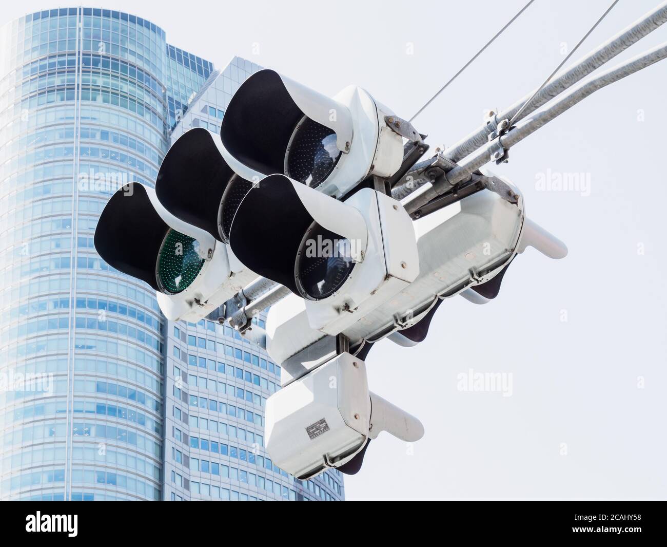Low angle shot of horizontal white traffic lights hanging in a street ...
