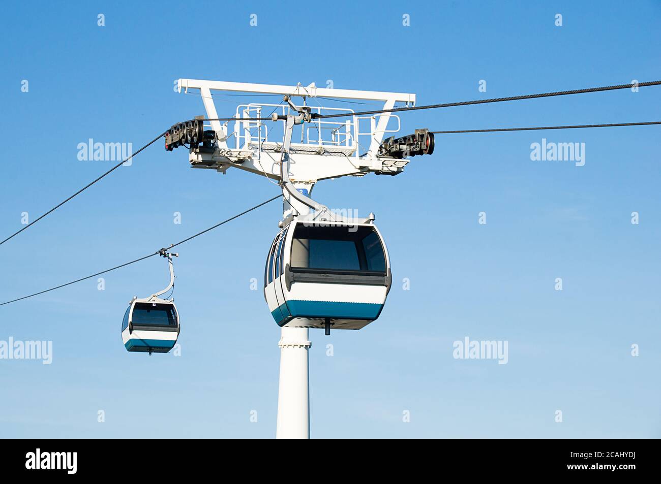 Closeup shot of a cable cars on a ropeway with a blue sky background ...