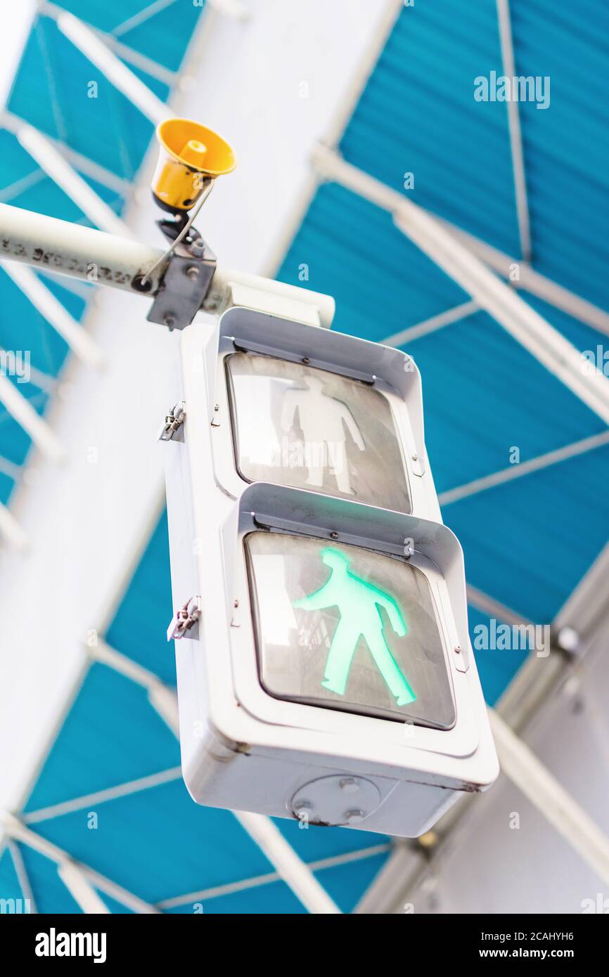 Low angle vertical shot of an electric pedestrian crosswalk sign with ...