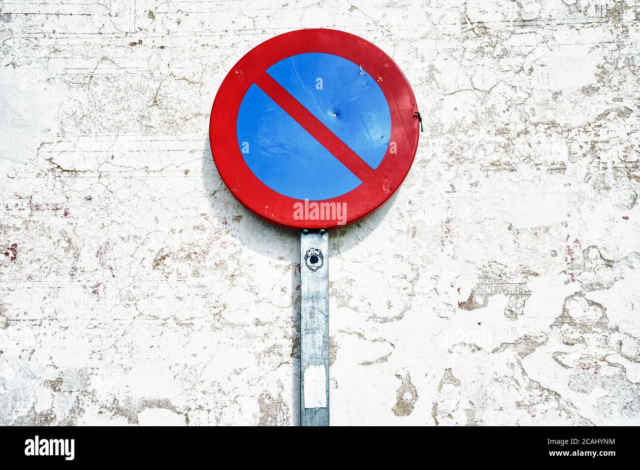 Round red blue no parking street sign on a white wall background Stock ...
