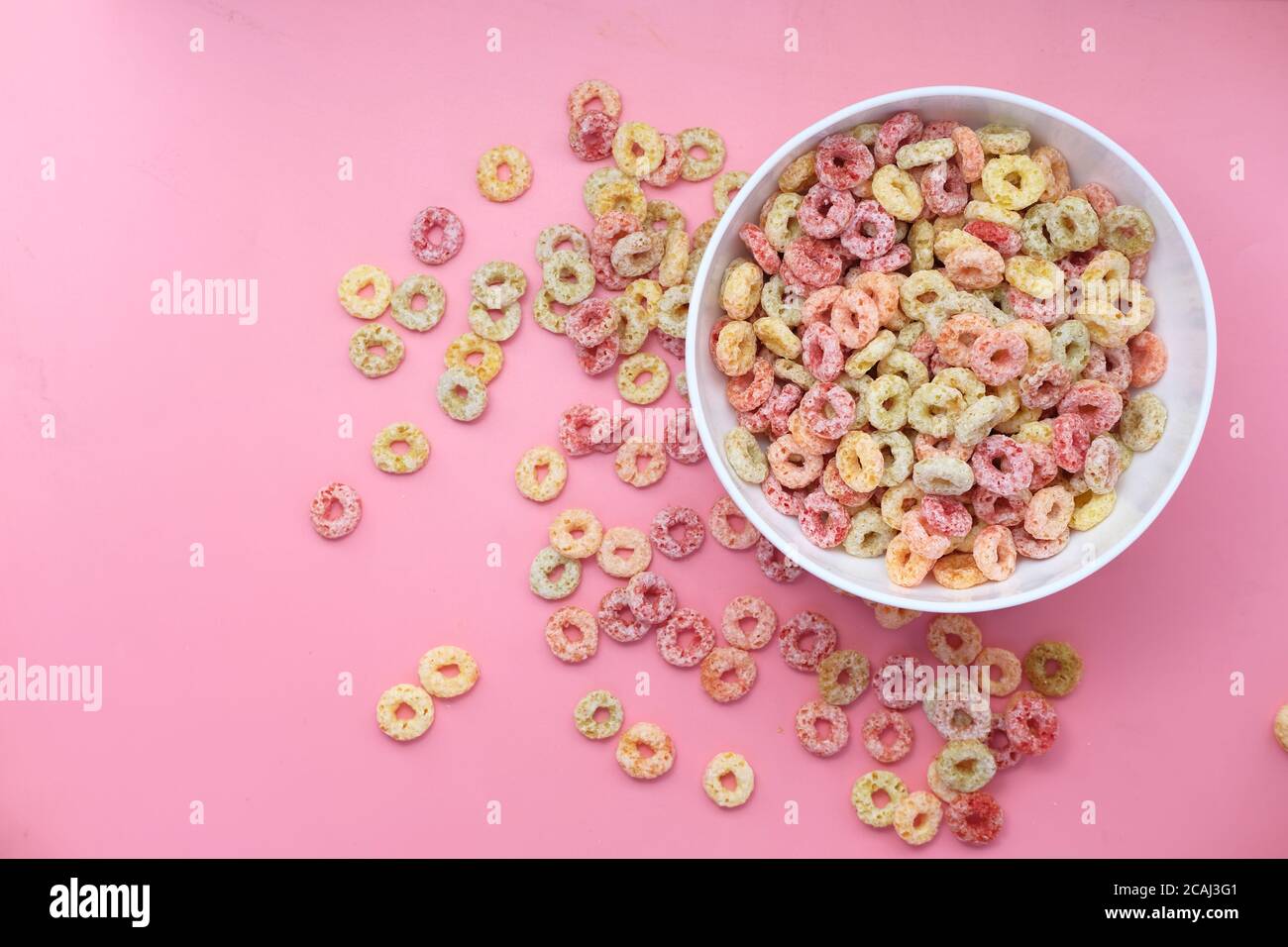 colorful ring corn flakes in a bowl on pink background Stock Photo - Alamy