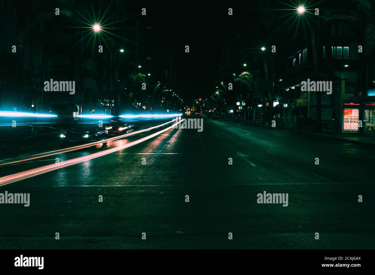 Dark city street at night with light trail from speeding car Stock ...
