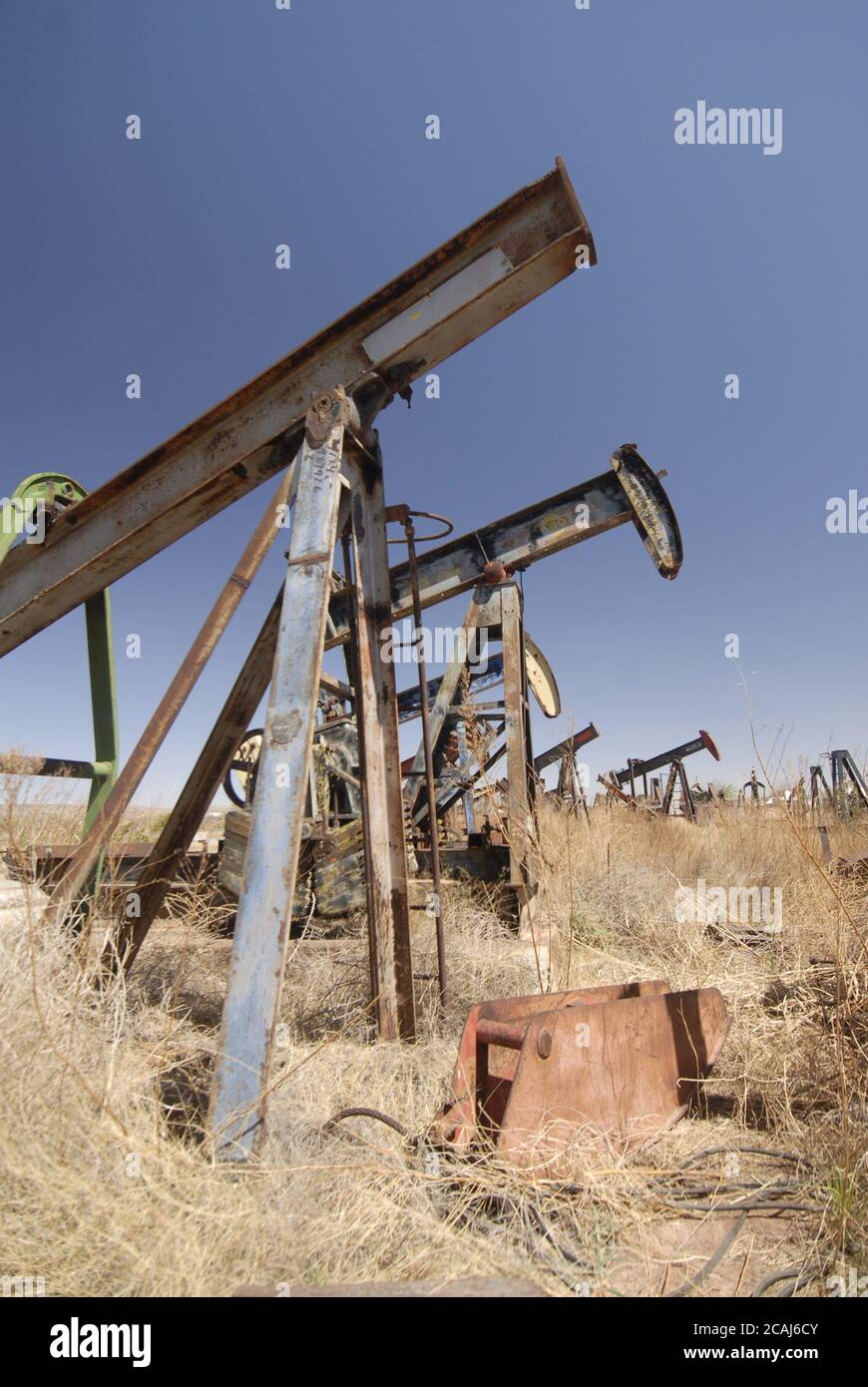 McCamey, Texas USA, March, 2006: Rusting hulks of oil well pumping ...