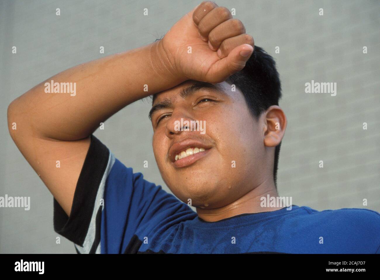 Hispanic teenager perspiring in Texas heat. Model Release. ©Bob ...