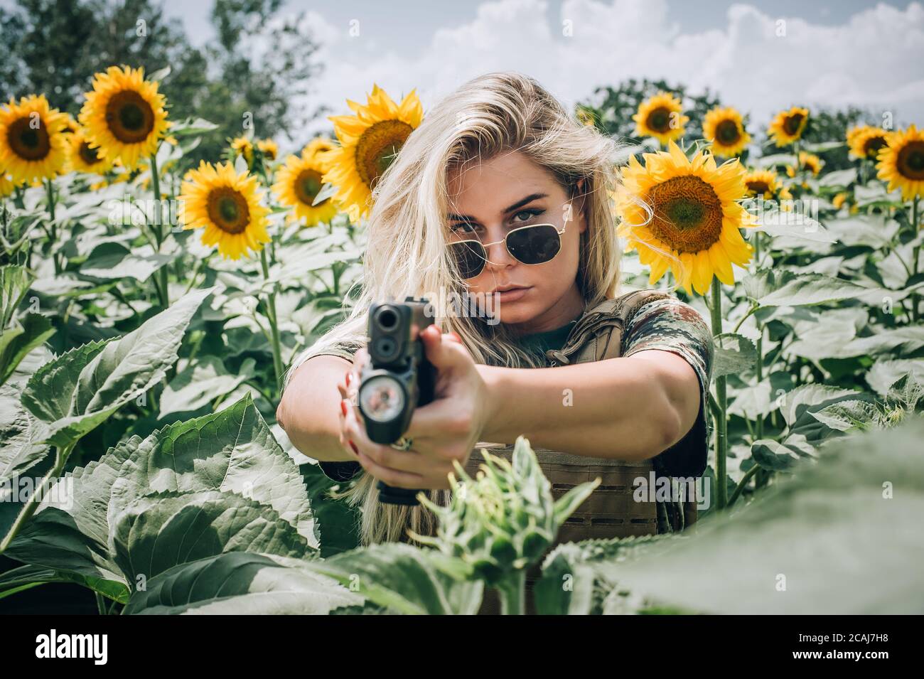 Beautiful and attractive female army soldier with gun. Woman with ...