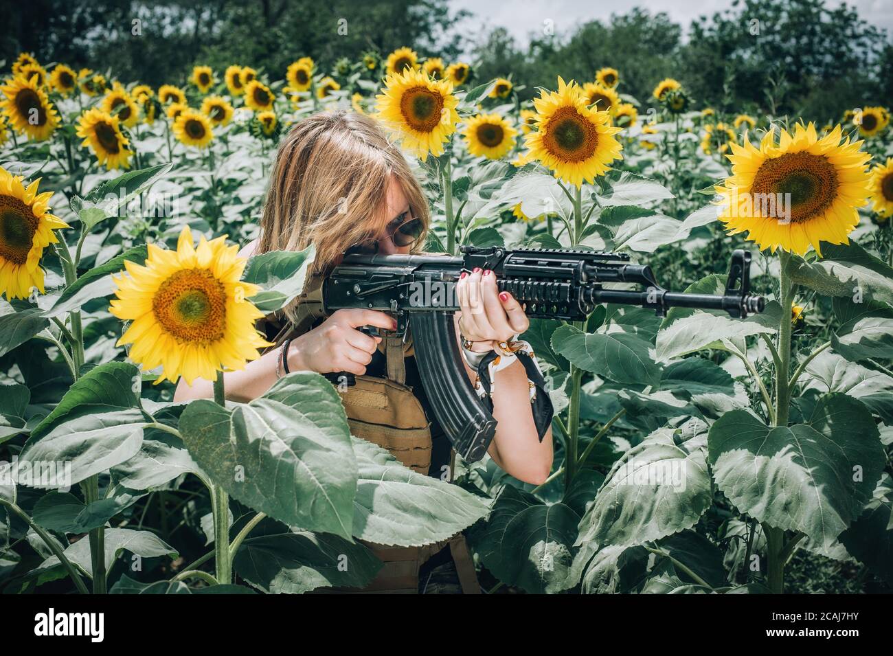 Beautiful and attractive woman soldier with rifle machine gun. Front ...