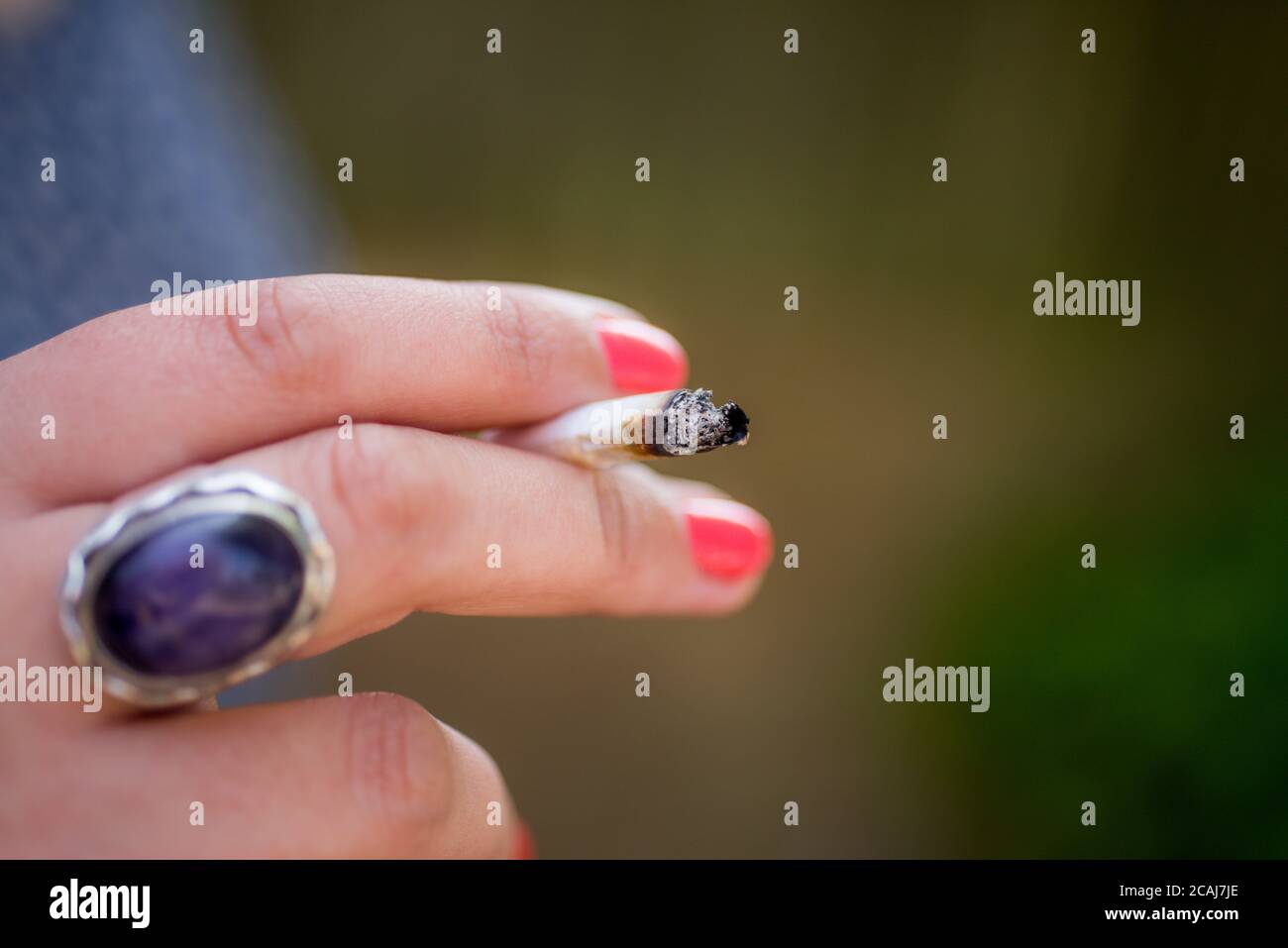 A person smoling a hand rolled cigarette Stock Photo - Alamy
