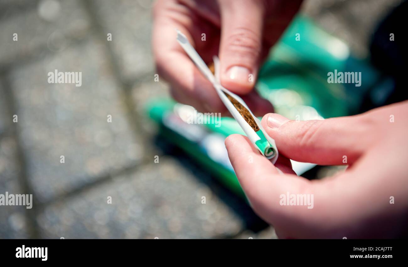 Woman smoking rolled up cigarette hi-res stock photography and images ...