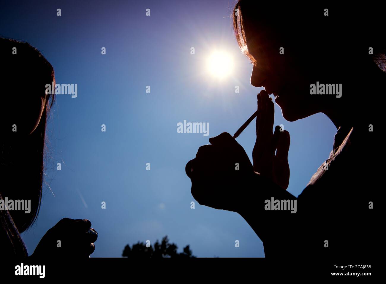Smoking a hand rolled cigarette Stock Photo - Alamy