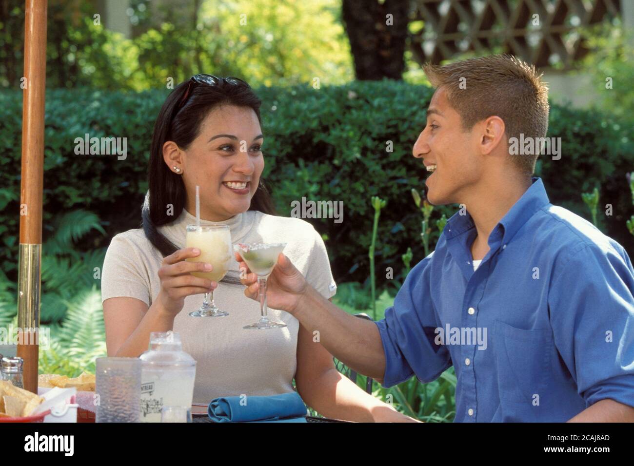 Austin Texas USA: Young Hispanic couple toast each other with Mexican ...