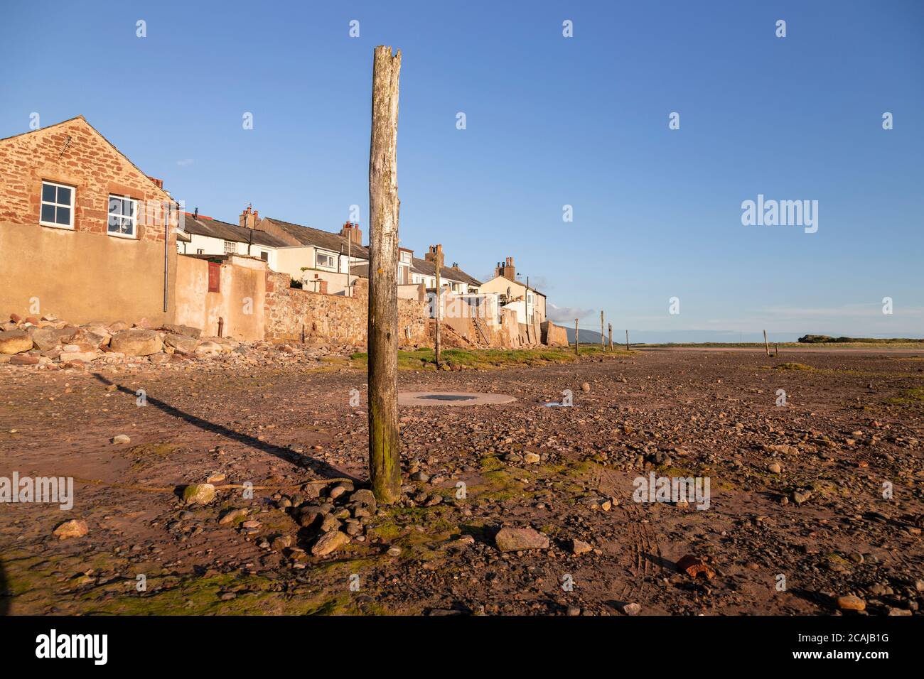 Old mooring post and houses at Ravenglass, Lake District, England Stock ...