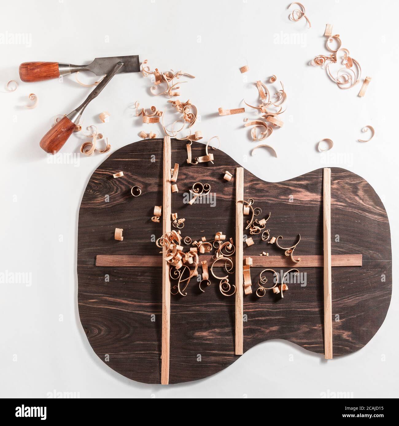 Back of guitar under construction with chisels and wood chips Stock ...