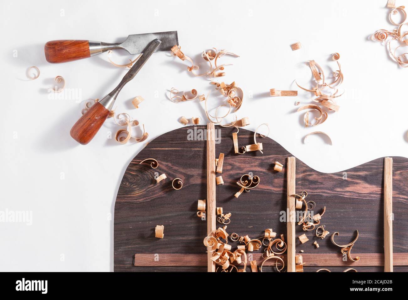 Back of guitar under construction with chisels and wood chips Stock ...