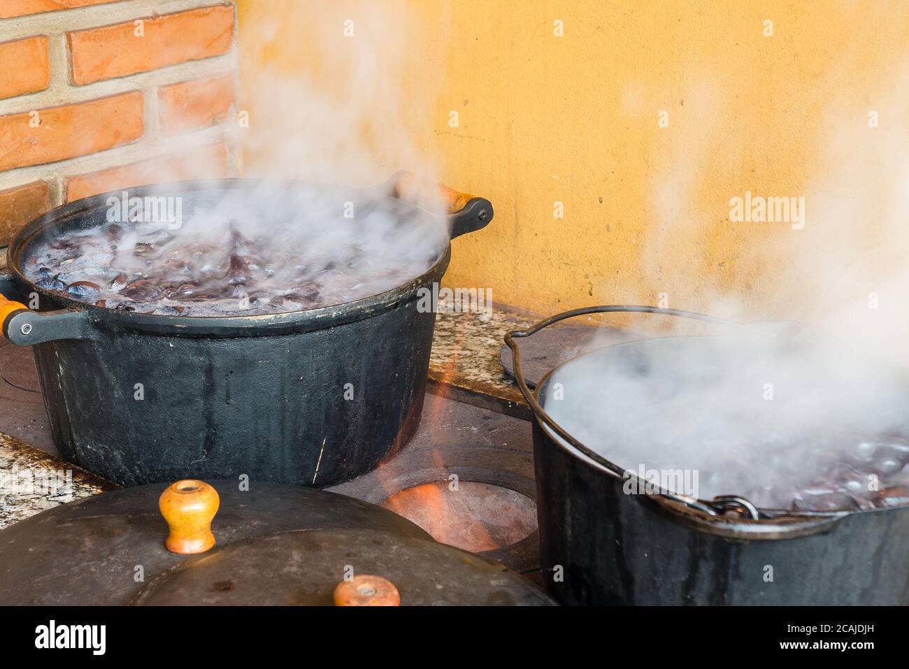 Black pots on wood fire hi-res stock photography and images - Alamy