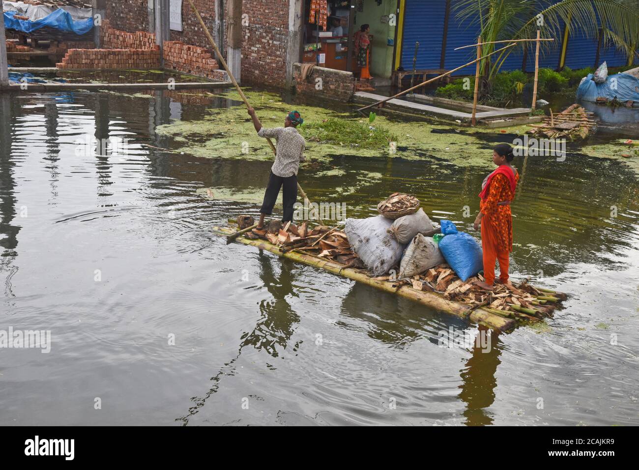 Village man ride on makeshift raft made of banana trees in the flood ...