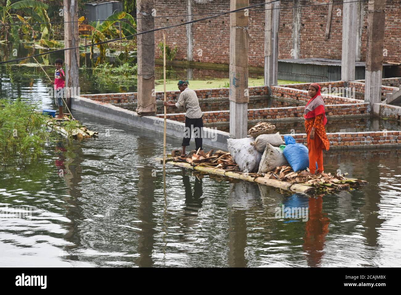 Village man ride on makeshift raft made of banana trees in the flood ...