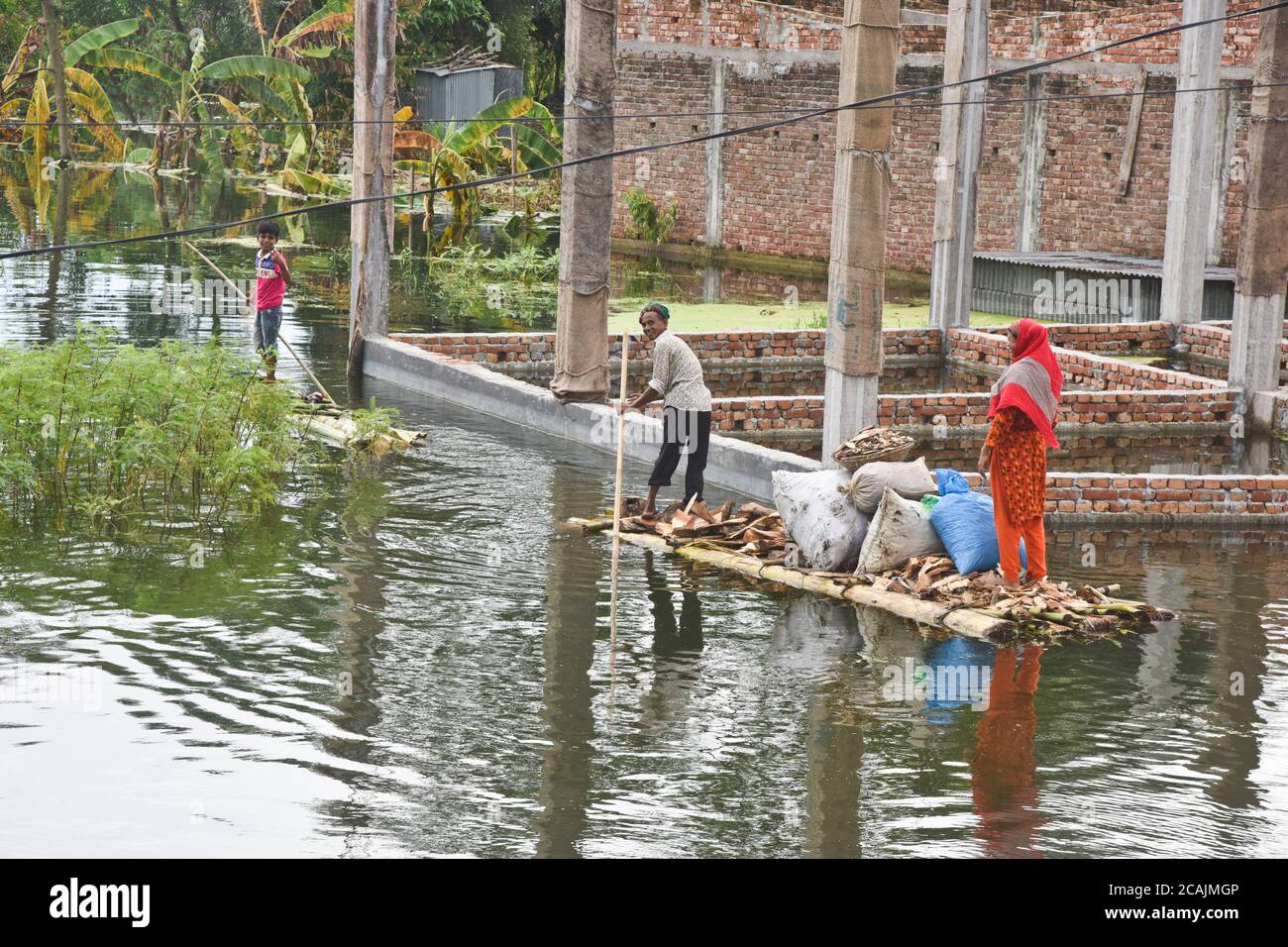Village man ride on makeshift raft made of banana trees in the flood ...
