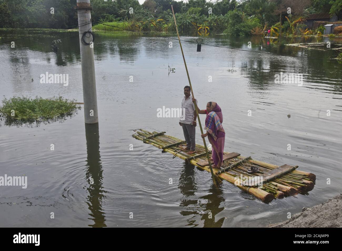 Village woman ride on makeshift raft made of banana trees in the flood ...