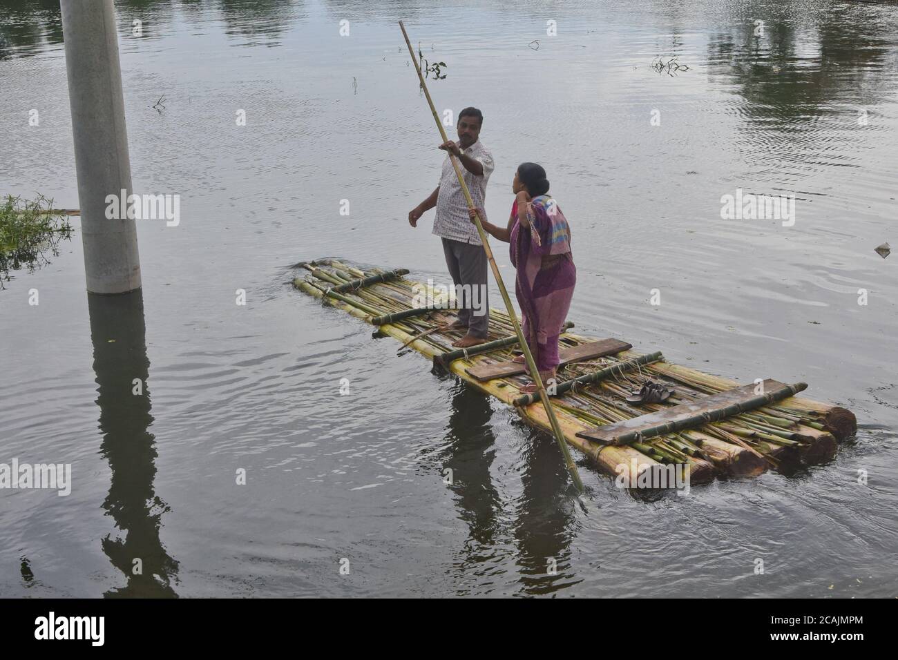 Village woman ride on makeshift raft made of banana trees in the flood ...