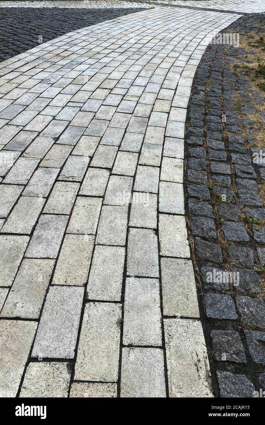 Pavement is lined with old stone. Gray retro stone texture. Pedestrian ...