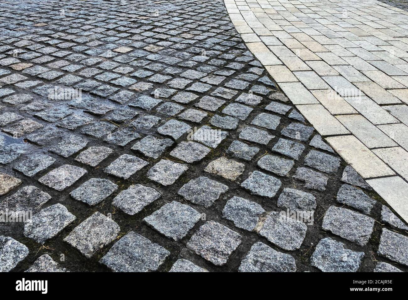 Pavement is lined with old stone. Gray retro stone texture. Pedestrian ...