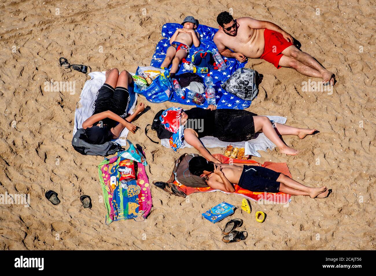 People enjoy the sun and the warm weather during the heat wave at a ...