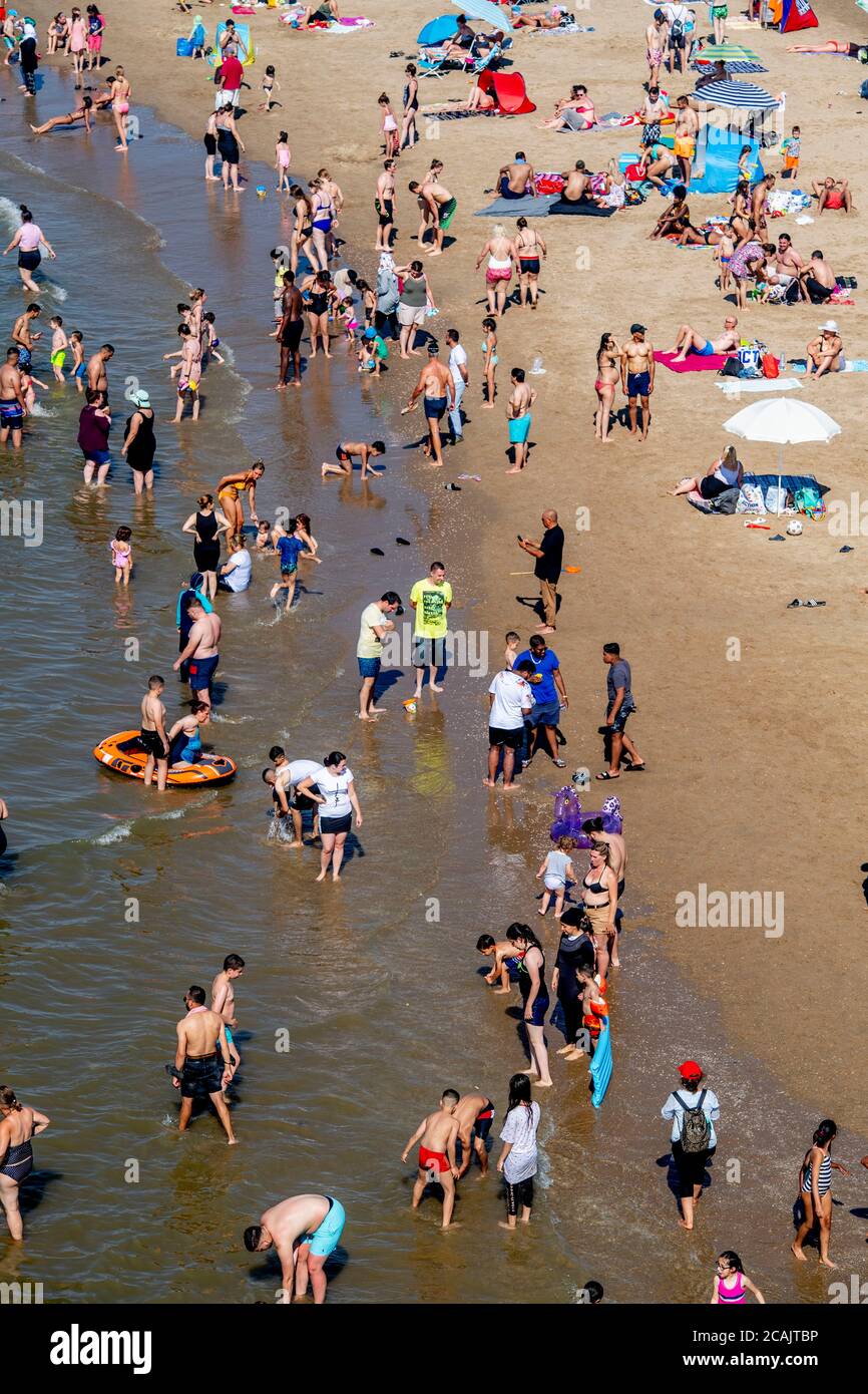 People enjoy the sun and the warm weather during the heat wave at a ...
