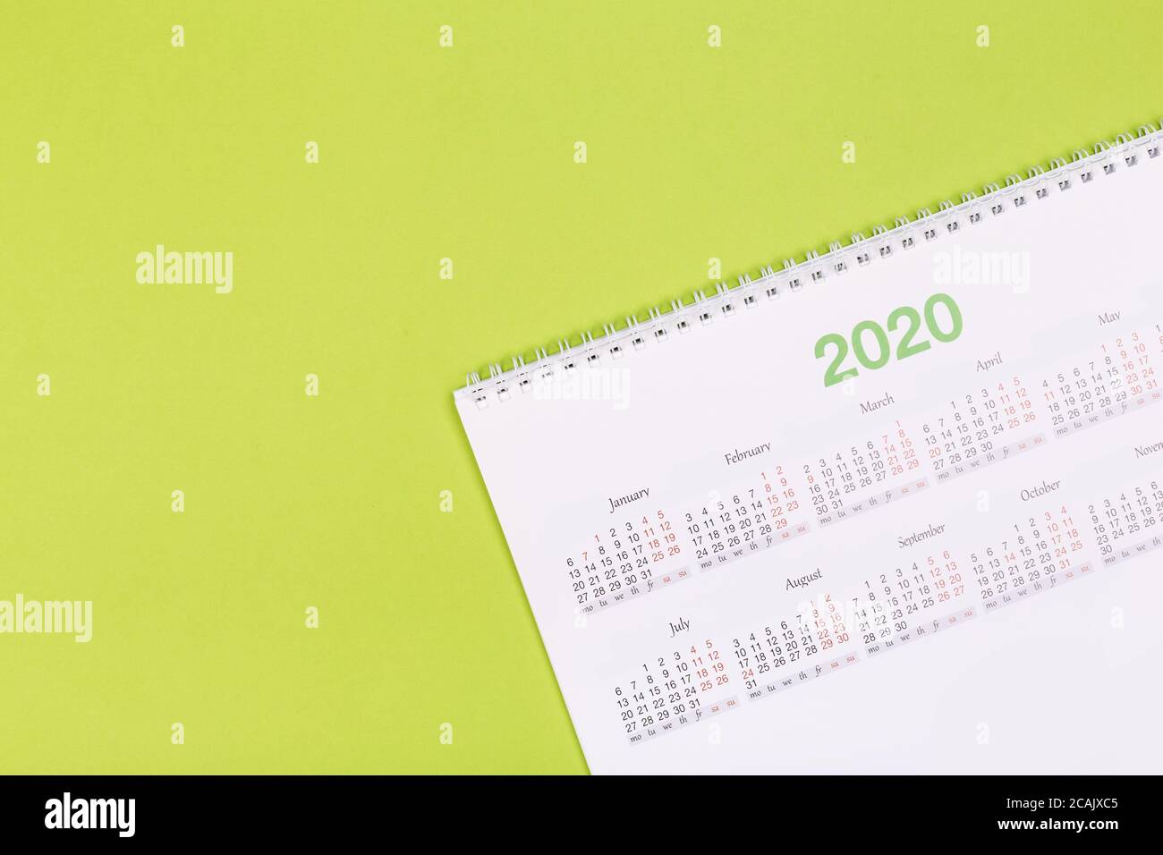 Open calendar on the table with green background, planning a business ...