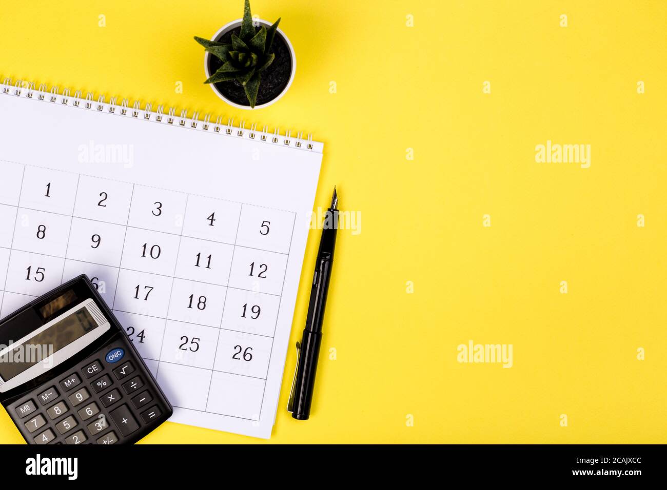 White clean calendar on solid yellow background with copy space ...
