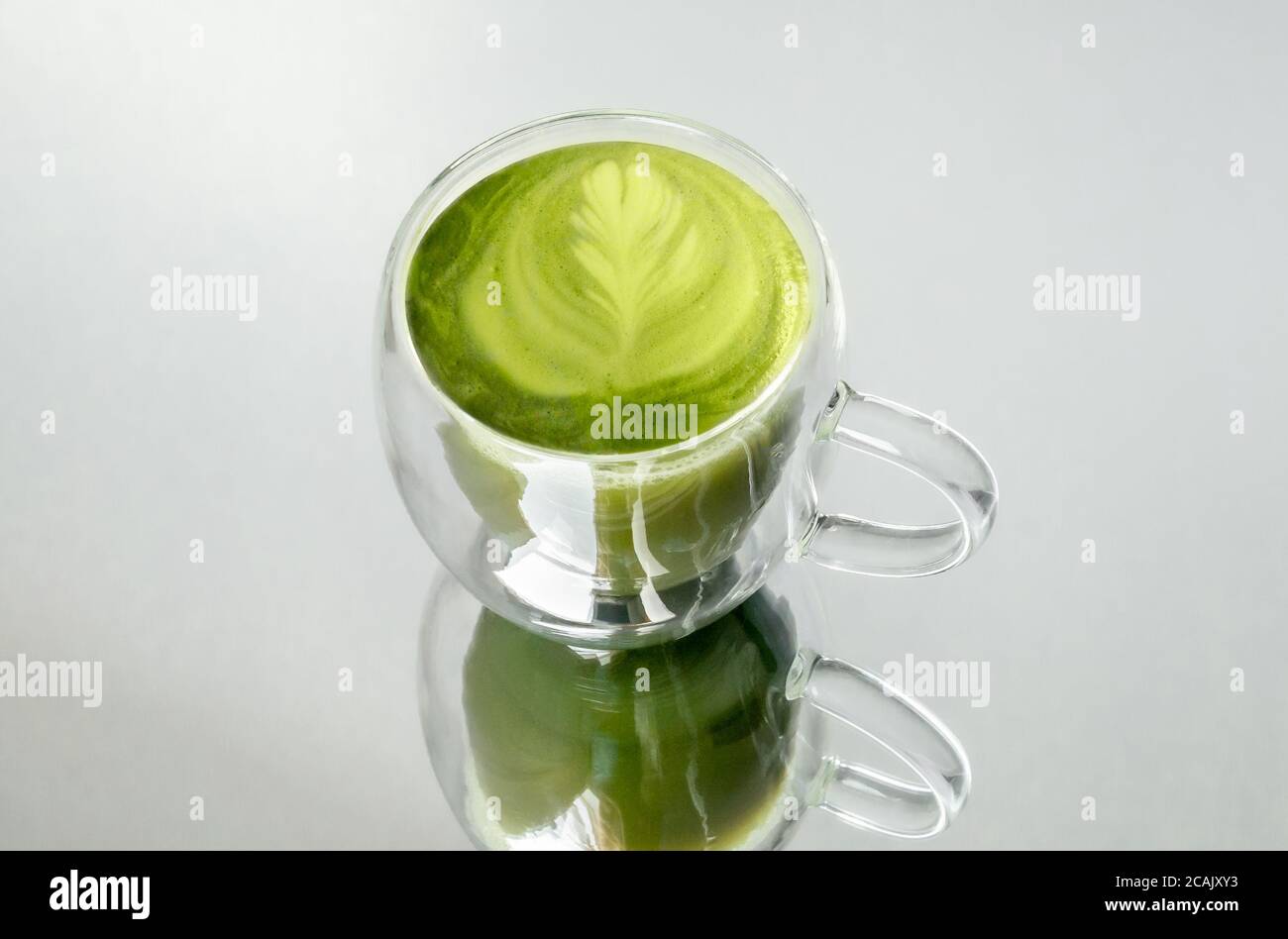 Single cup of a fresh matcha tea reflected on the glass Stock Photo - Alamy