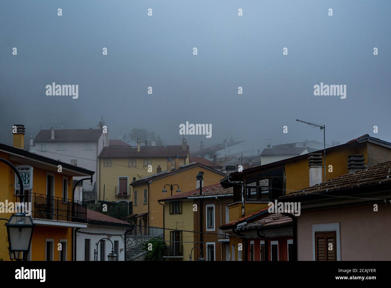 Fog over Italian village Stock Photo - Alamy