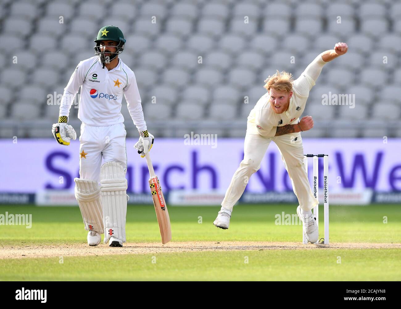 England's Ben Stokes (right) in action during day three of the First ...