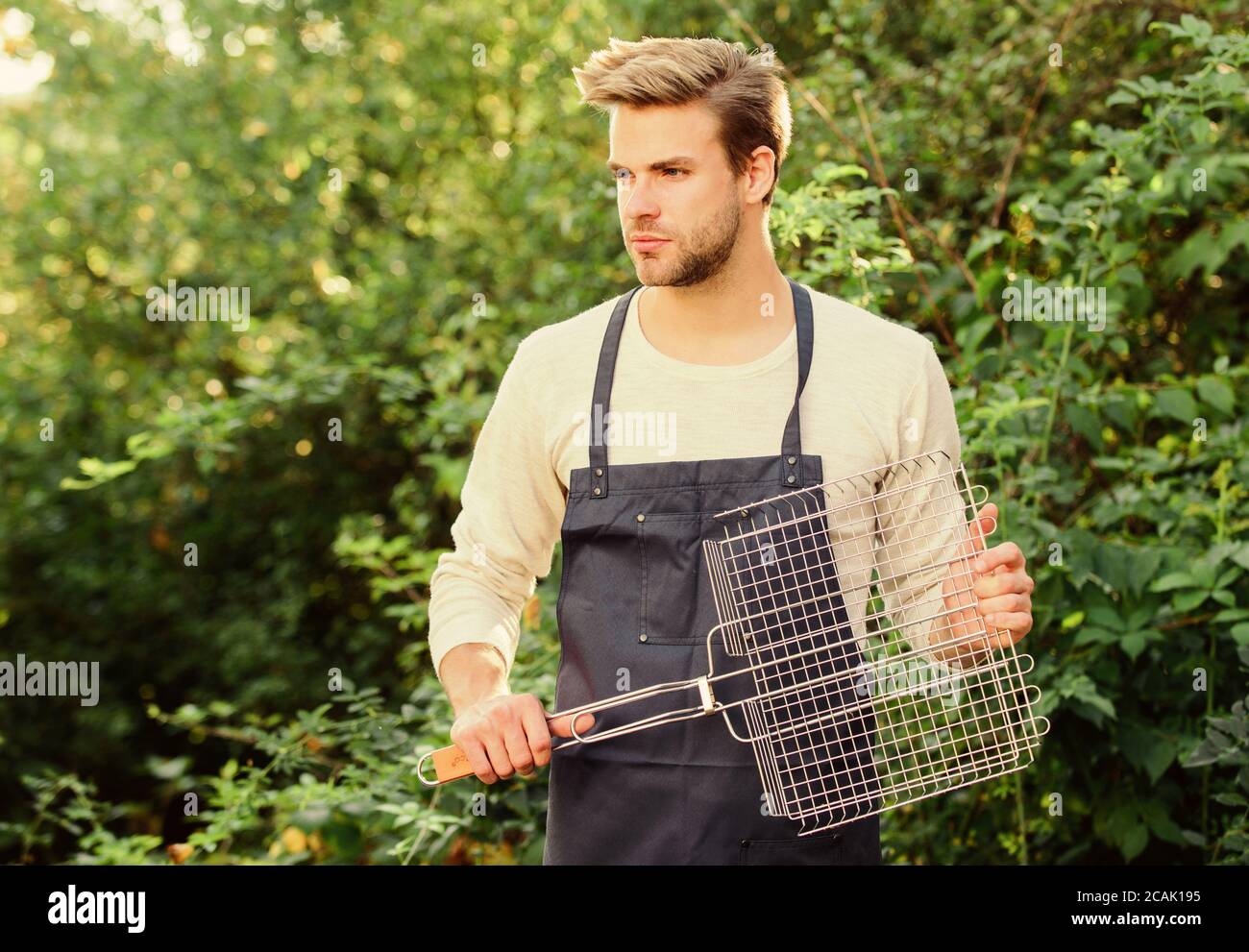 Picnic concept. Man hold grilling grid. Grilling food. Backyard ...