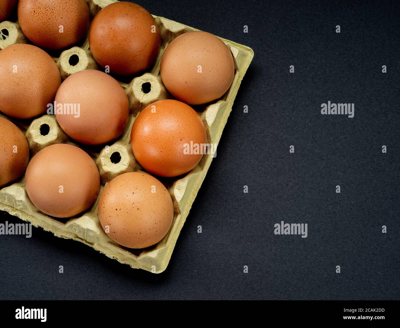 Group of eggs in balance on a black background Stock Photo - Alamy