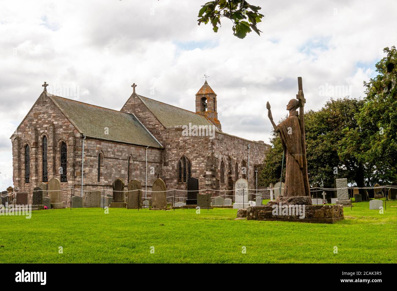 A statue of St Aidan sculpted by Kathleen Parbury from red concrete on ...