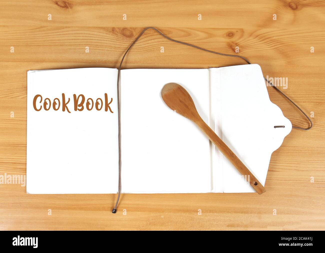 Open cookbook with empty pages and wooden spoon Stock Photo - Alamy