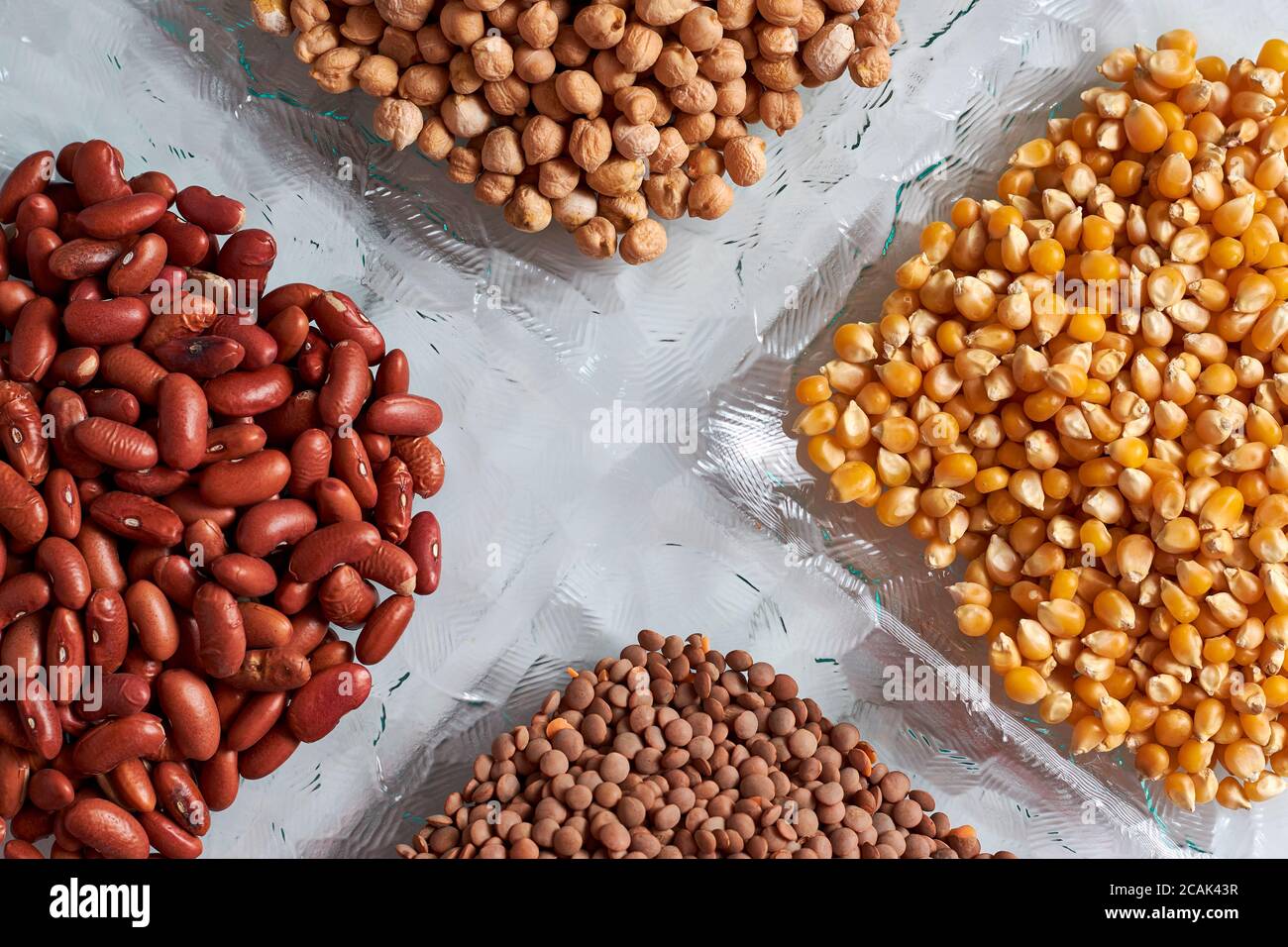 Top view closeup of red kidney beans, brown lentils, corn kernels and ...