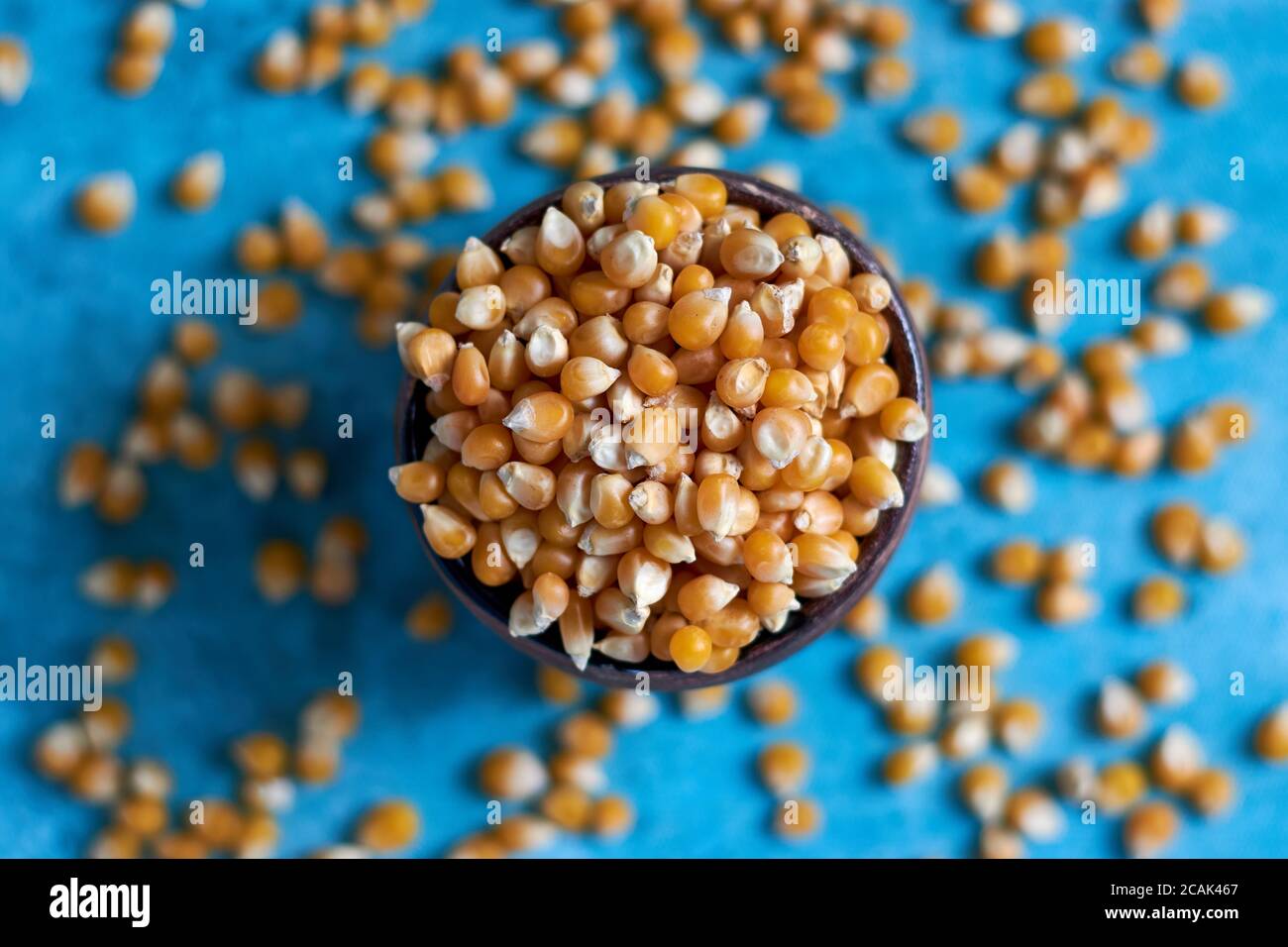 Top view closeup shot of a container full corn kernels with some of it ...