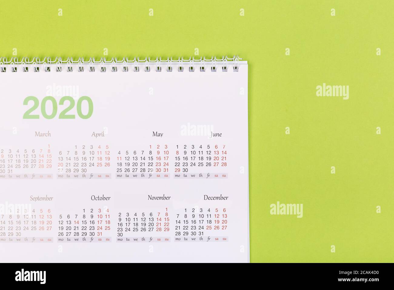 Open calendar on the table with green background, planning a business ...