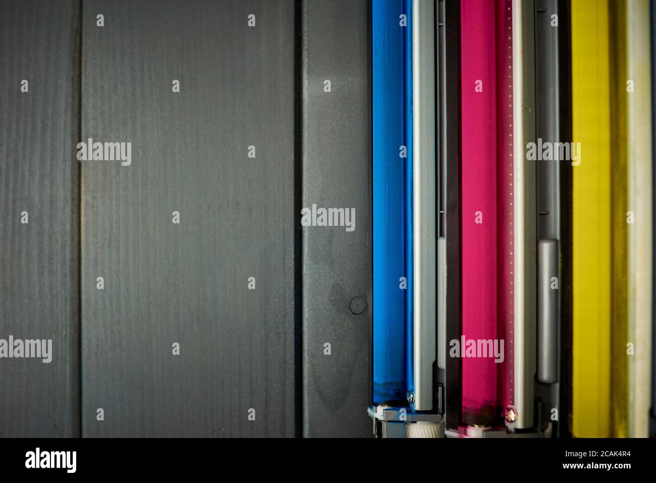 Top view of rollers in a set of laser printer color cartridges on gray ...