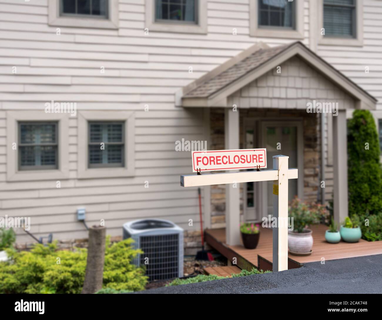 Mockup of a foreclosure sign in front of a modern townhome or townhouse ...