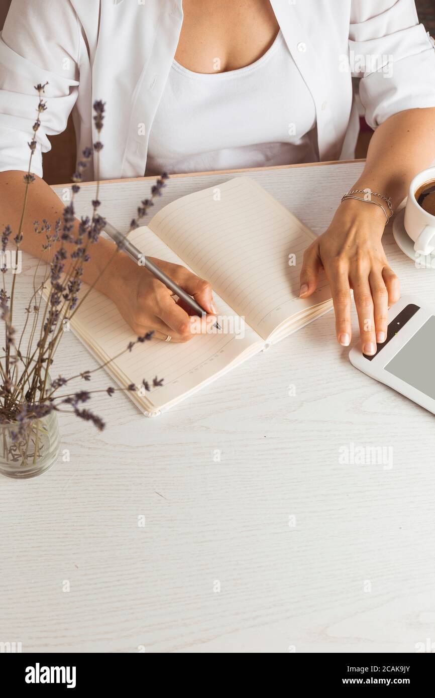 Woman writes in notebook sitting hi-res stock photography and images ...